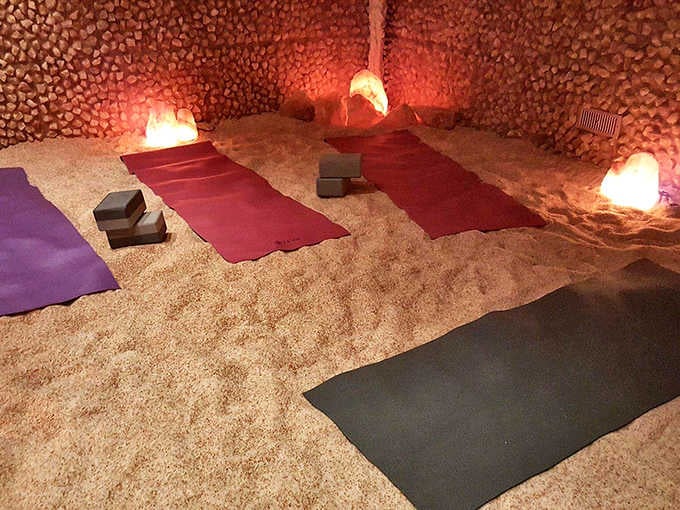Purple and orange lighting transforms this salt sanctuary into something between spa and enchanted grotto.