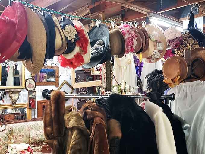 Vintage hats and fur coats hang in a row, practically begging you to try on a different era entirely.