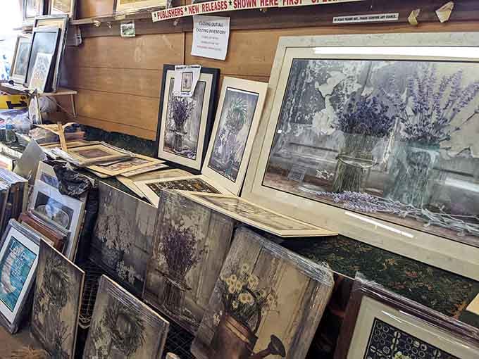 Framed prints and artwork stacked deep, because every blank wall is just an opportunity waiting to happen.