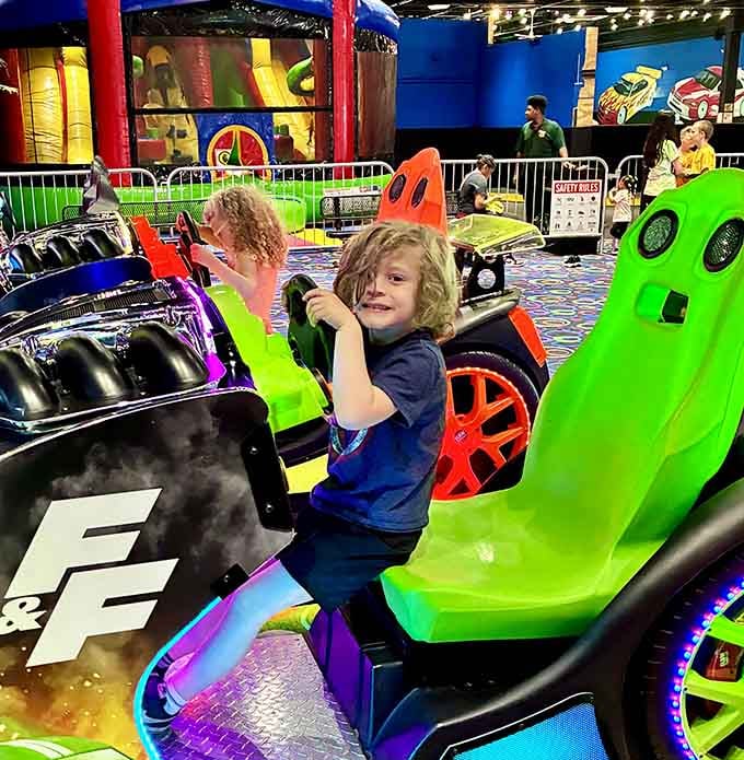 That grin behind the wheel says this kid has already decided he's the fastest driver in the building.