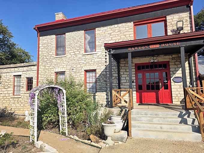 The Barton House stands in limestone and red trim like it has absolutely nothing to prove to anyone.