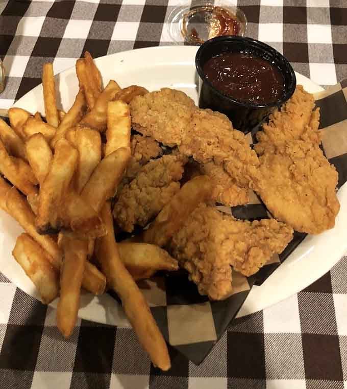 Really Good Chicken Tenders with barbecue sauce and fries. The menu calls them really good, and the menu is not lying.