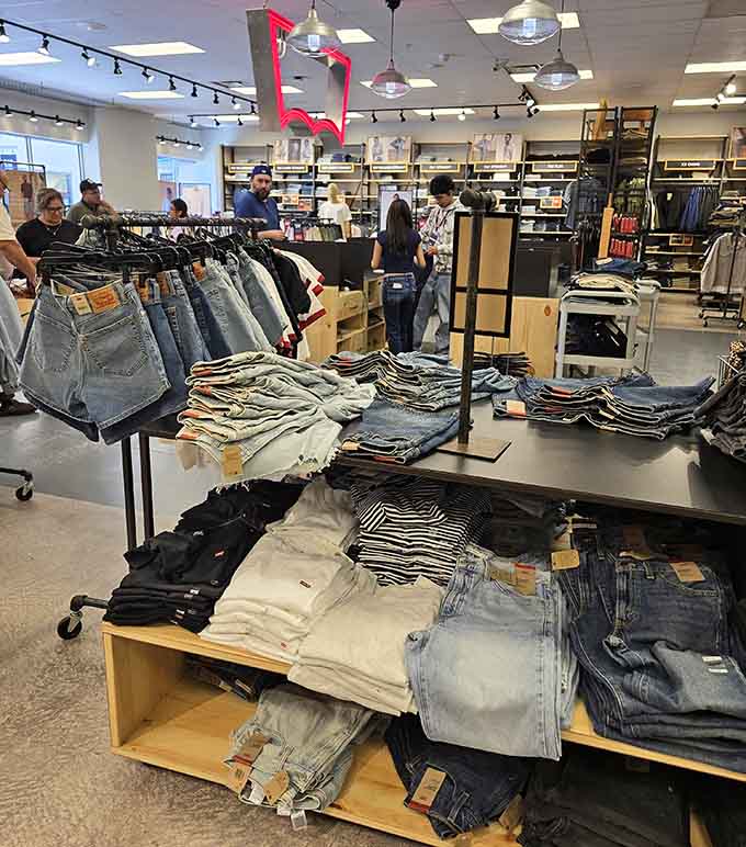 Levi's denim stacked high and shoppers browsing happily. A classic American brand at prices that actually make sense.