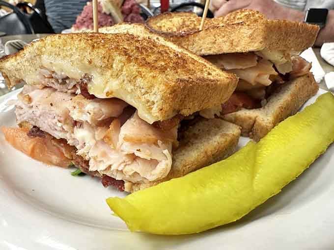 Generous, golden, and stacked with care, the Turkey Club here means serious business on toasted bread.
