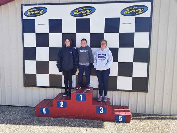 Three friends, one checkered backdrop, and the kind of smiles that only come from a genuinely great day out.