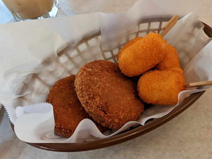 Crab cakes and crab claw skewers sharing one basket. Honestly, this is the kind of teamwork we should all aspire to.