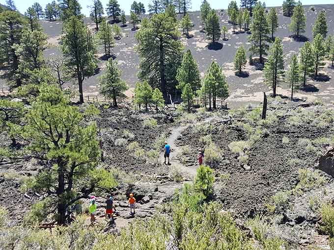 Tiny hikers, massive volcanic landscape. Perspective check delivered, free of charge, courtesy of Sunset Crater.