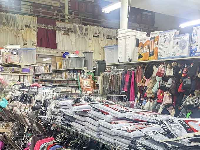 Curtains hanging overhead, clothing racks stretching deep, fans boxed and ready, this aisle has more going on than most entire stores.