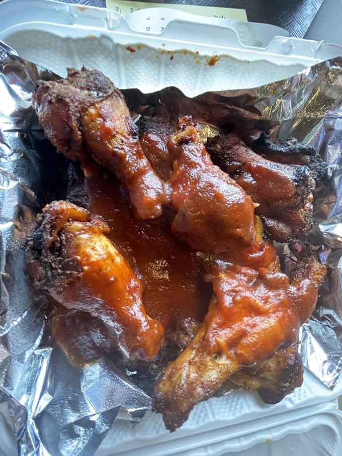 Saucy, smoky wings piled high in foil, the kind of sight that makes you forget you had other plans.