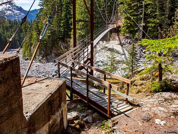 Those concrete anchors hold the bridge steady while the creek below does its best impression of controlled chaos.
