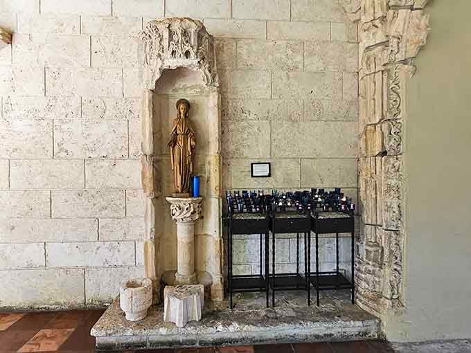 Centuries of devotion carved right into the wall, with a quiet candle keeping the whole thing company.