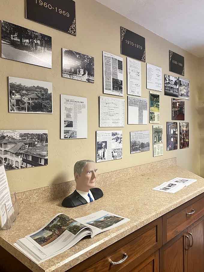 Decades of history pinned to one wall, with a distinguished bust keeping a very close eye on all of it.
