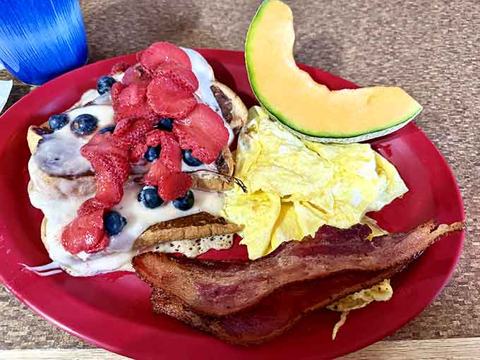 Fresh berries on pancakes with perfectly scrambled eggs, because sometimes breakfast needs to look this good.