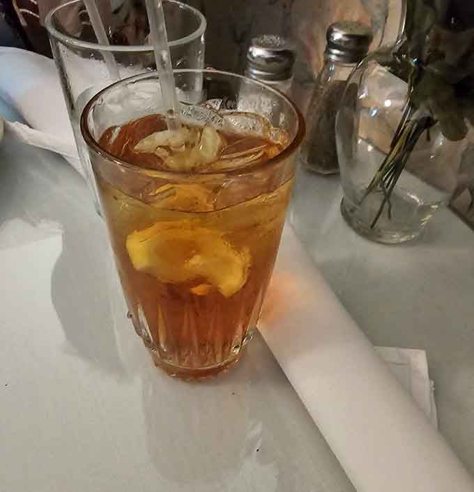 A tall glass of iced sweet tea with lemon, the South's official handshake, cold, amber, and completely non-negotiable.