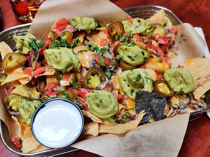 Nachos loaded with jalapeños and all the fixings prove that ghosts aren't the only spirits getting generous portions here.