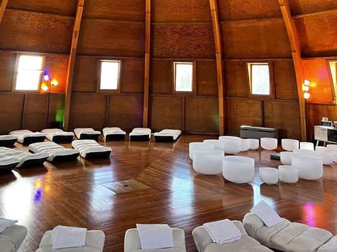 White mats, crystal singing bowls, and warm wooden walls, this is what relaxation looks like when aliens help with the blueprints.