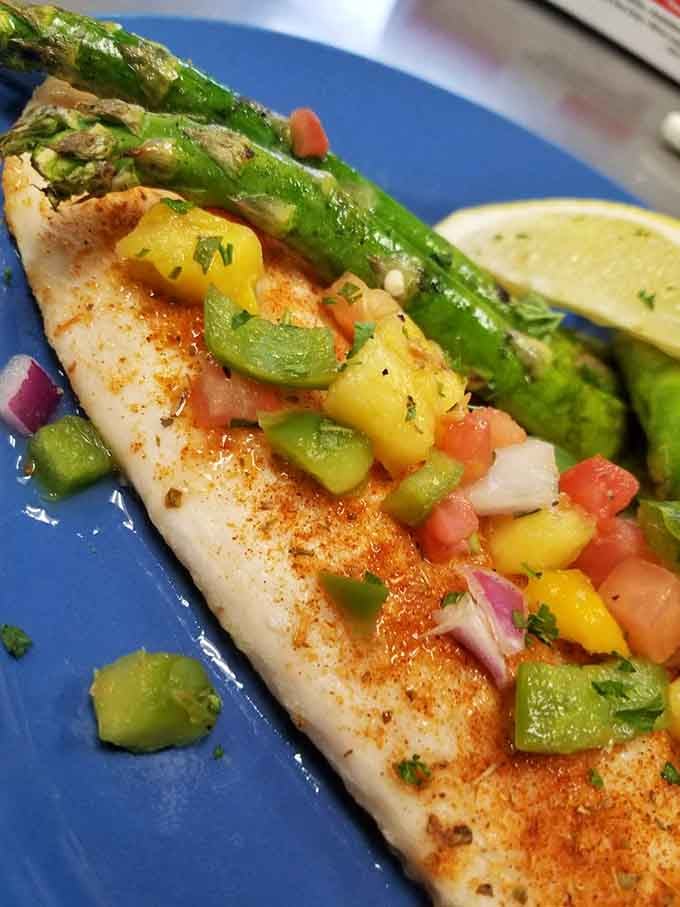 Fresh fish dressed in colorful salsa and citrus, looking like a postcard from somewhere considerably warmer than Minnesota.