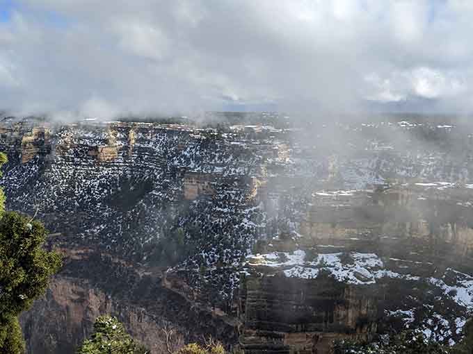 Fog wrapping around the canyon walls like a slow, mysterious curtain call for the greatest show on Earth.