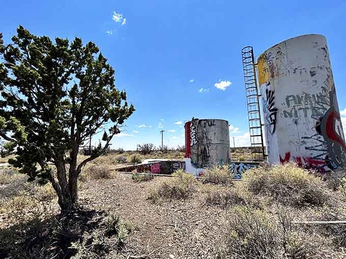 Old fuel tanks transformed into canvases, proving one generation's trash becomes another's outdoor art gallery.