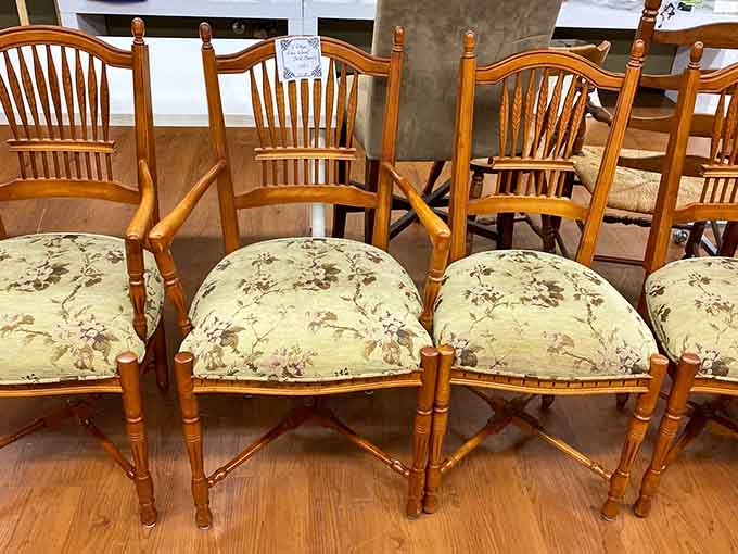 Spindle-back wooden chairs with floral cushions so charming, your dining room will never forgive you for walking past them.