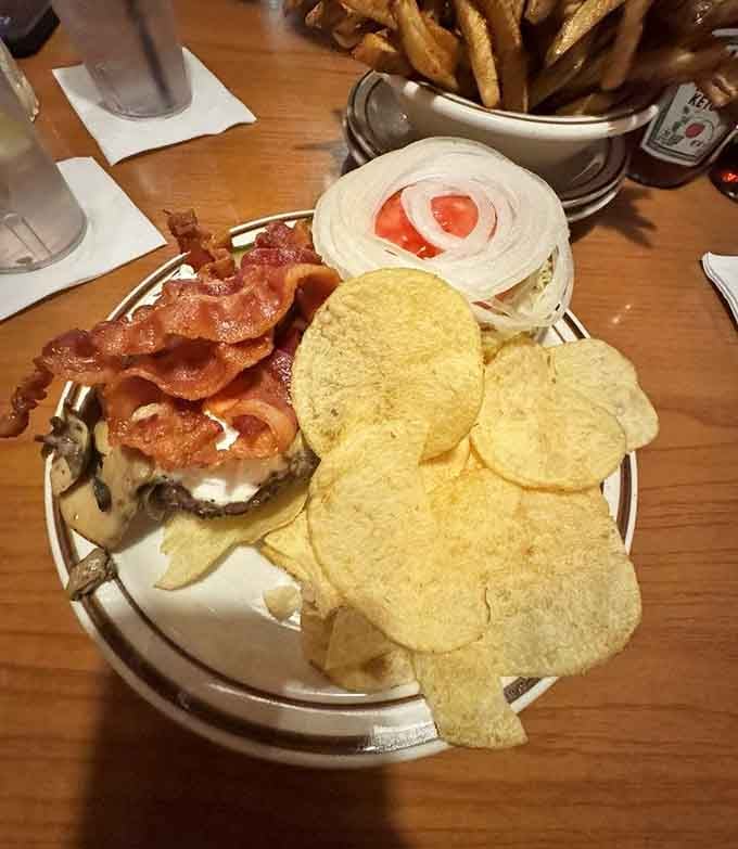 Sour cream, mushrooms, bacon, and melted cheese on a grilled kaiser roll, the kind of burger that makes you go quiet mid-bite.