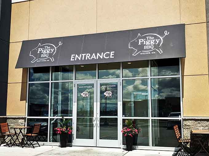 The Piggy BBQ entrance welcomes hungry souls seeking smoky salvation and napkins, lots of napkins definitely.