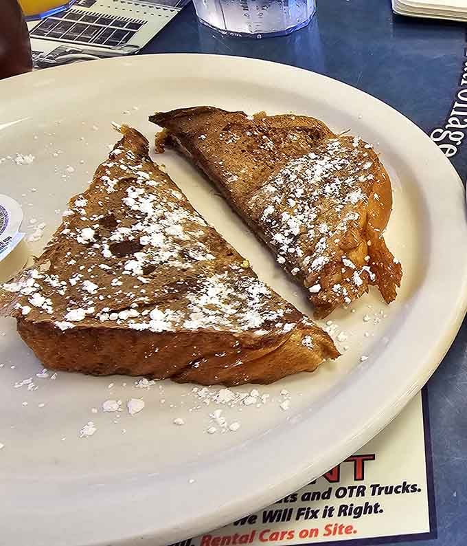 Thick, golden French toast dusted with powdered sugar, the kind of breakfast that makes you forgive your alarm clock.