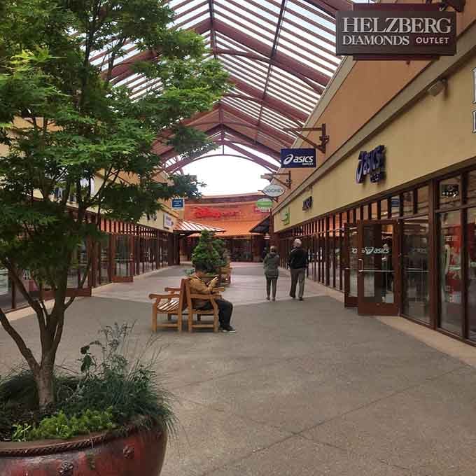 Tree-lined walkways, wooden benches, and store signs stretching into the distance, this mall means serious business.