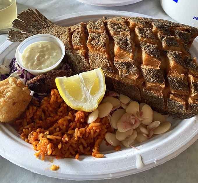 A whole fried flounder plated with red rice and lima beans, this is Lowcountry cooking at its most confident.