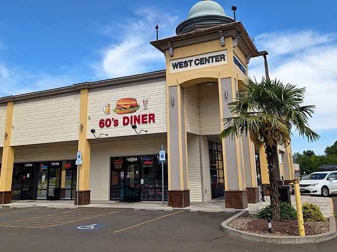 That cheerful burger graphic on the 60's Diner sign under a wide blue sky is basically a billboard for pure happiness.