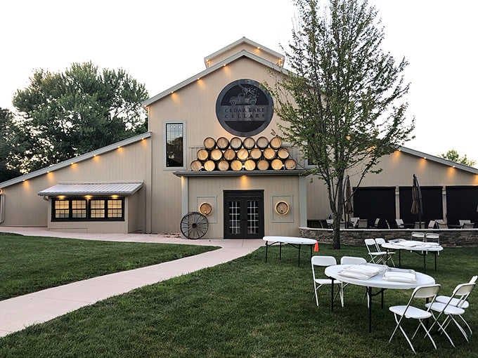 Stacked barrels glowing under warm evening lights give Cedar Lake Cellars a festive, welcoming personality.