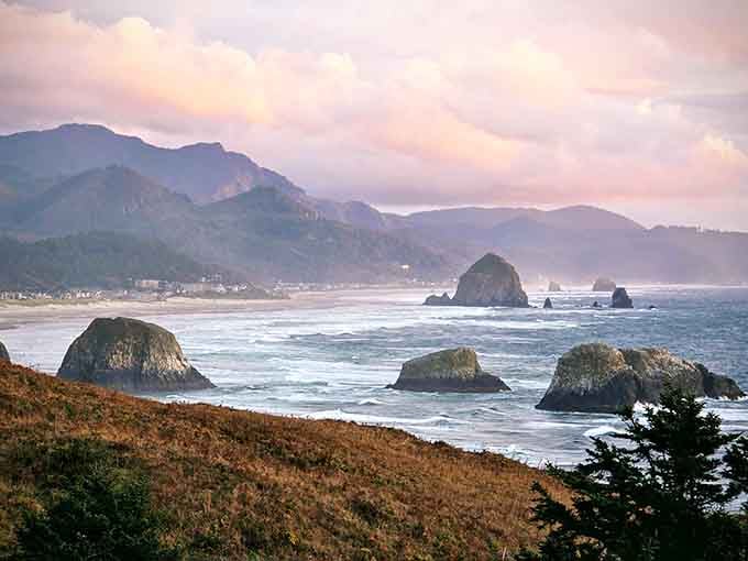 Those sea stacks rising from misty waters look like nature's own chess pieces waiting for giants to play.