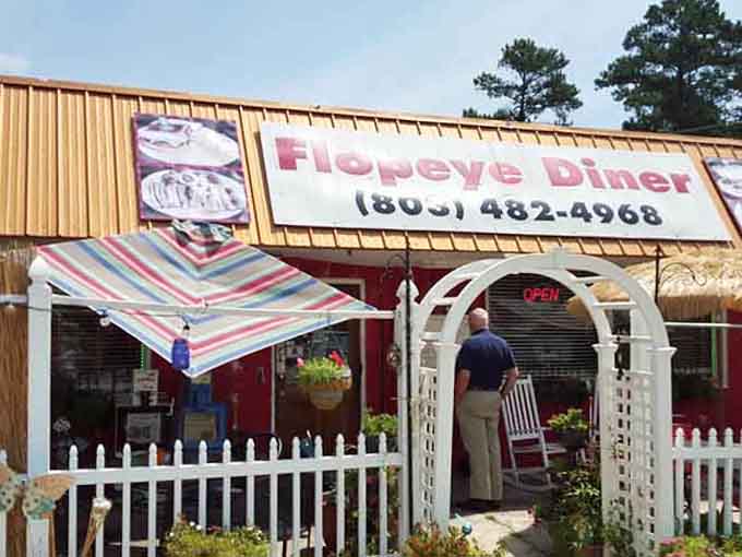 That striped awning and white picket fence entrance make the Flopeye Diner look like the friendliest front porch in Great Falls.