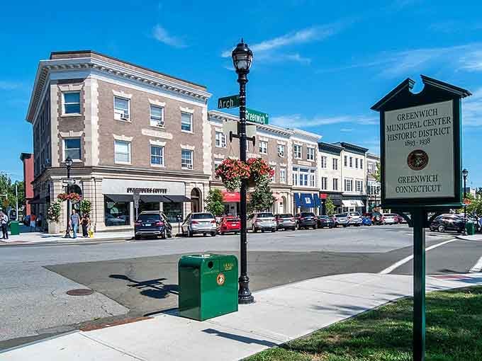 A historic district marker stands proudly at the corner, quietly announcing that Greenwich takes its architectural legacy just as seriously as its reputation.