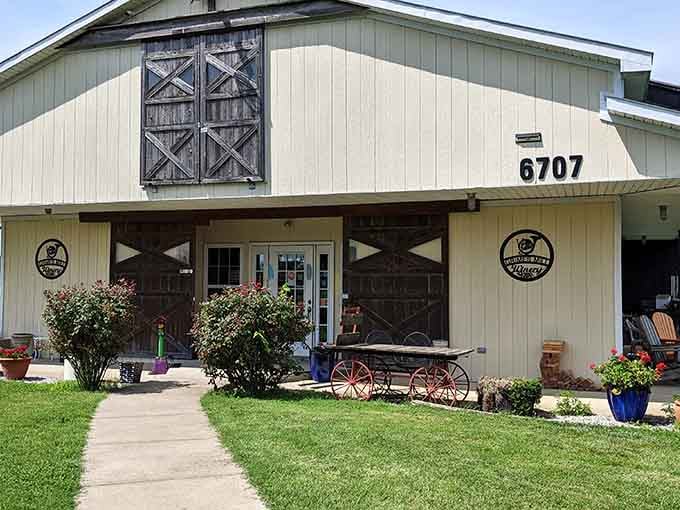 Those weathered cross-pattern barn doors flanking a crisp glass entrance create a perfect blend of old Kentucky charm and modern hospitality.