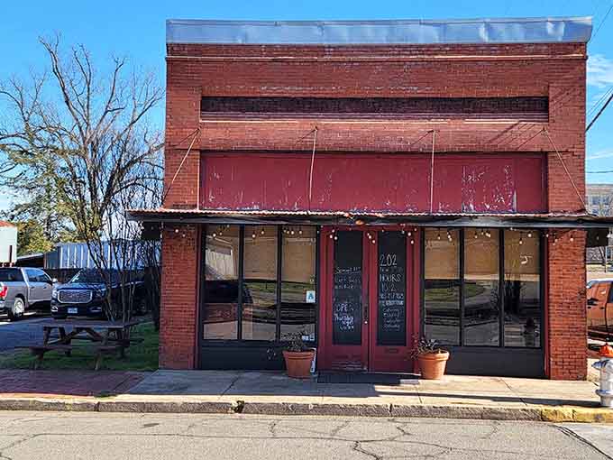 Red brick, string lights, and a chalkboard door sign &mdash; this old storefront has more character than most restaurants three times its size.