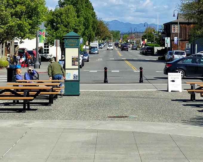Gilkey Square on a sunny afternoon in La Conner &mdash; benches, mountains in the distance, and absolutely zero reasons to rush.