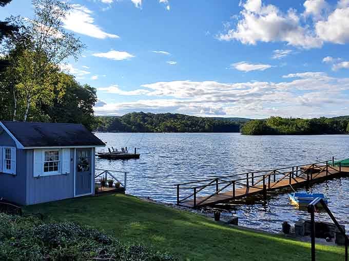 A weathered dock stretches into Lake Waramaug's glassy water, practically whispering, "Come sit here and relax awhile."