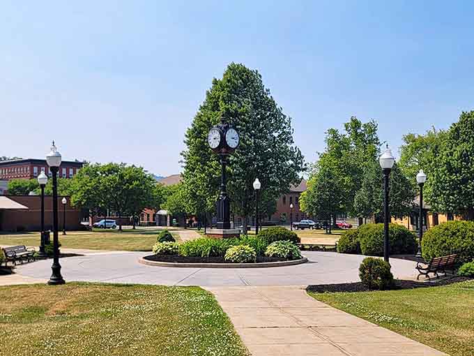 Olean's charming town square welcomes visitors with a classic clock tower, lush green trees, and inviting benches perfect for relaxing afternoons!