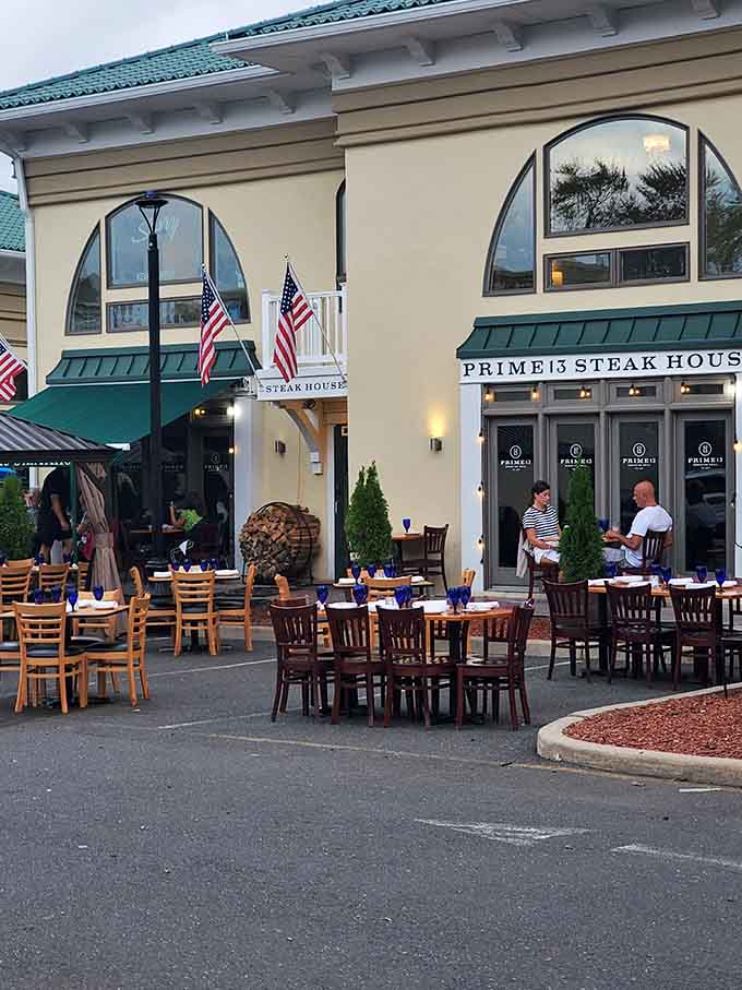 American flags, stacked firewood, blue glassware, and open-air tables — Prime 13's patio is Shore dining at its most inviting.