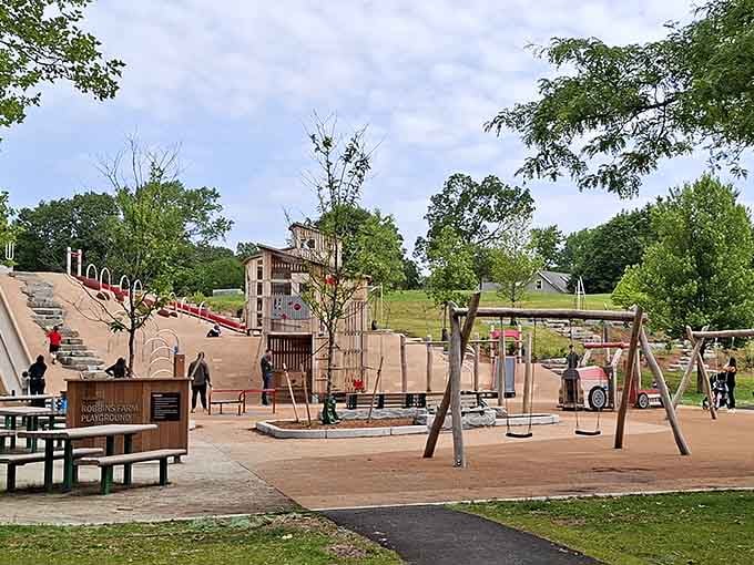 This rustic playground sprawls across the hillside like a miniature farm village waiting to be explored.