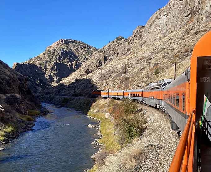 Hugging the Arkansas River through Royal Gorge, this orange train makes canyon walls feel gloriously, thrillingly close.