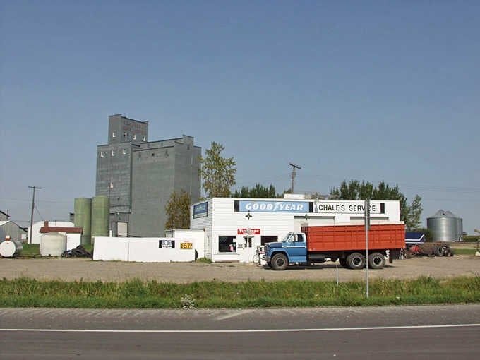 Chale's Service station and a towering grain elevator tell the whole honest story of St. Vincent in one frame.