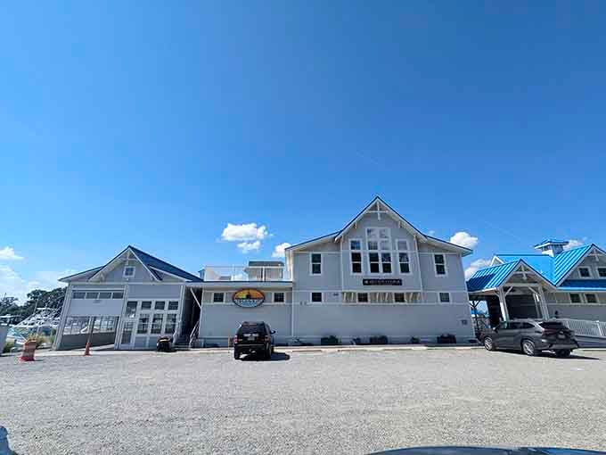 Clean white siding, a marina logo, and a sky so blue it hurts: Surf Rider Restaurant means serious waterfront business.