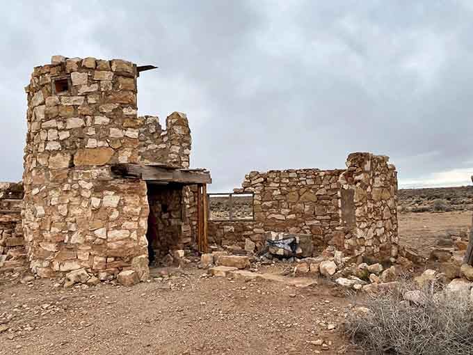 These stacked stone walls at Two Guns have been standing through wind, heat, and decades of curious visitors, and they're still not talking.