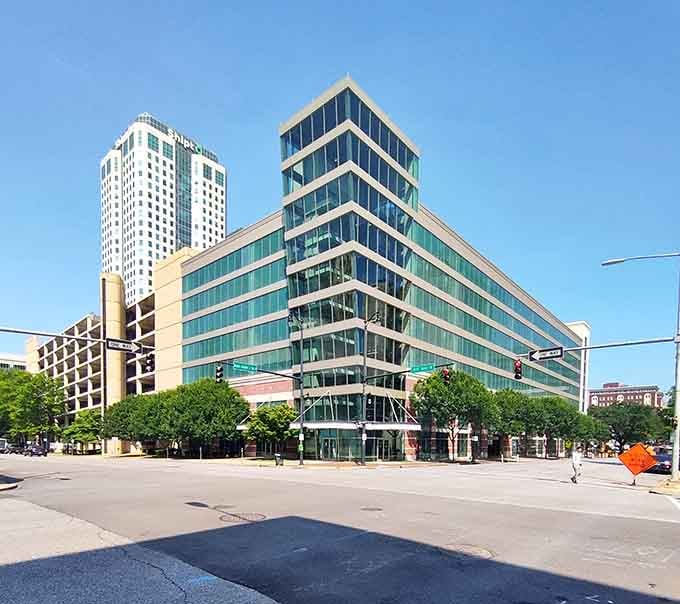 Modern glass towers reflect blue skies above streets where innovation meets Southern hospitality at every corner restaurant.