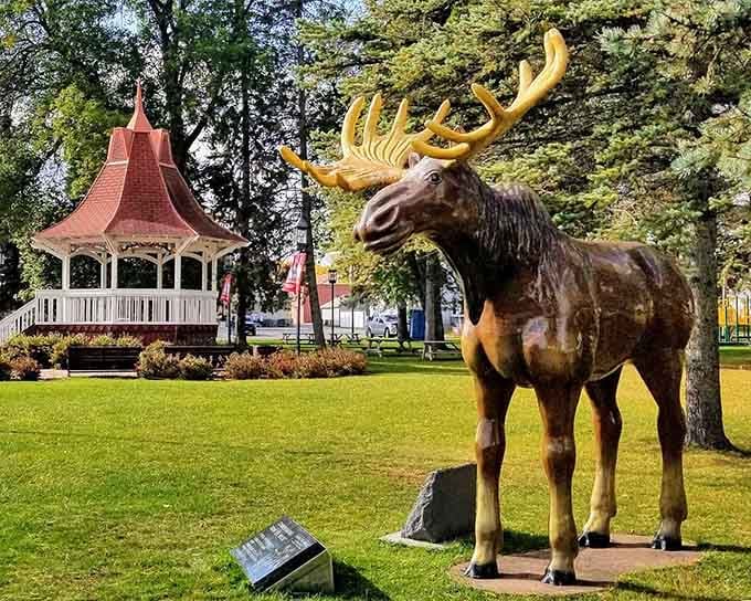 That handsome moose statue gazes confidently toward the gazebo, looking for all the world like he owns the whole park &mdash; and honestly, fair enough.