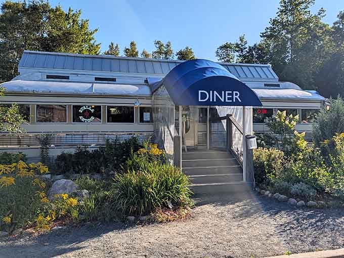Late afternoon sun catches the silver diner car just so, and suddenly Blue Mountain Lake feels like the best decision you've made all year.