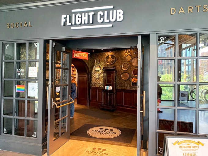 Rich wood paneling visible through those open doors hints at the British-inspired atmosphere waiting inside for dart enthusiasts.