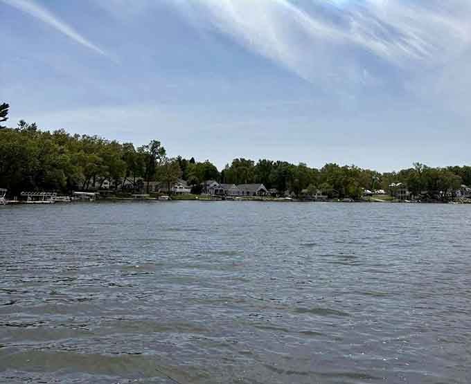 From out on the water, Koontz Lake's tree-lined shore and cozy homes look like a postcard nobody bothered to mail.